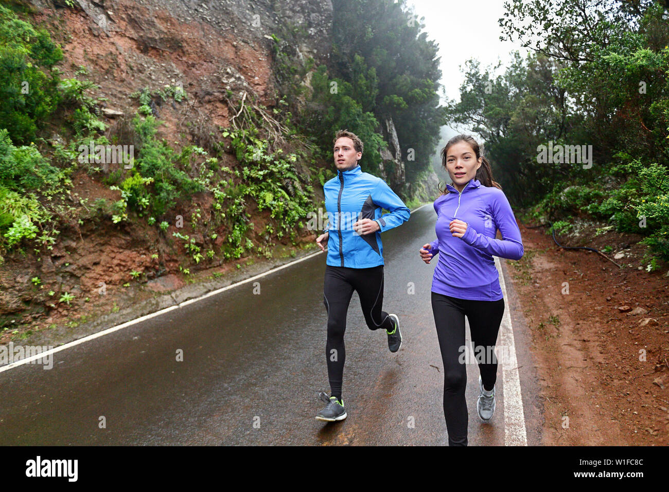 Healthy lifestyle people running on country road exercising. Runners ...