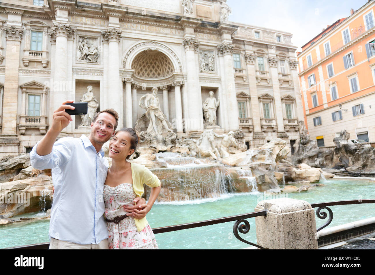 Tourist couple on travel taking selfie photo by Trevi Fountain in Rome ...