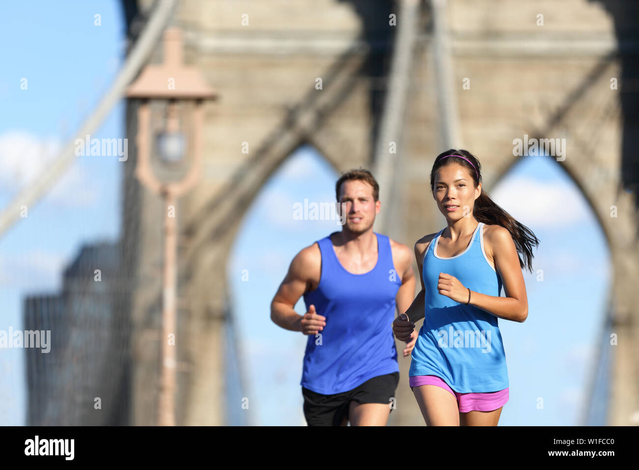 New York city runners running training for marathon on Brooklyn bridge ...