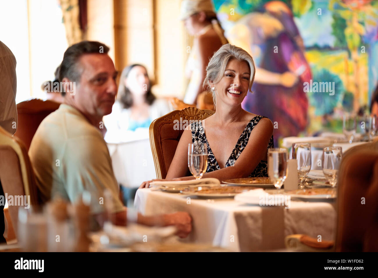 Couple sitting down at an upscale restaurant Stock Photo - Alamy
