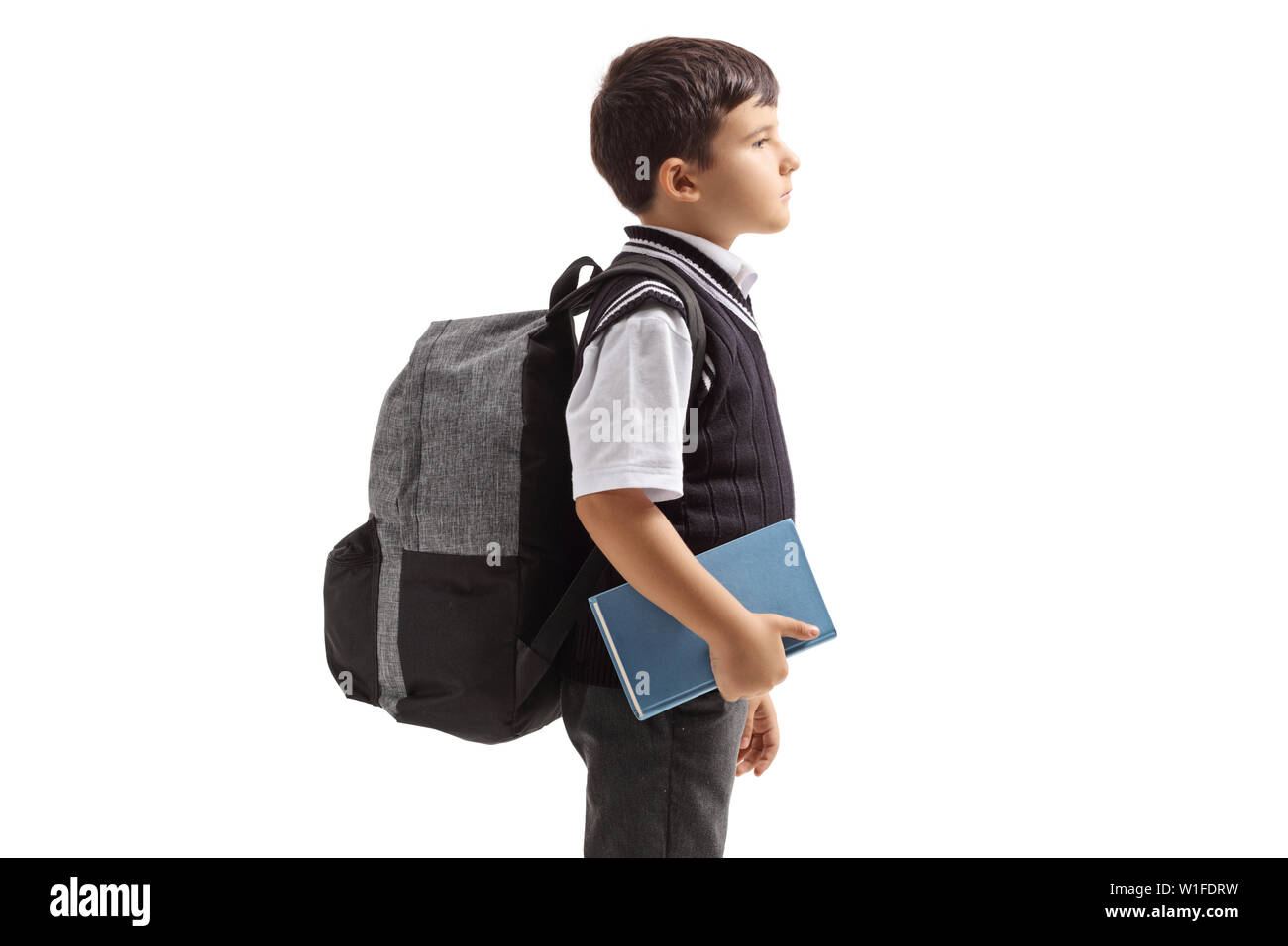 Profile view of a schoolboy in a uniform and a backpack isolated on ...