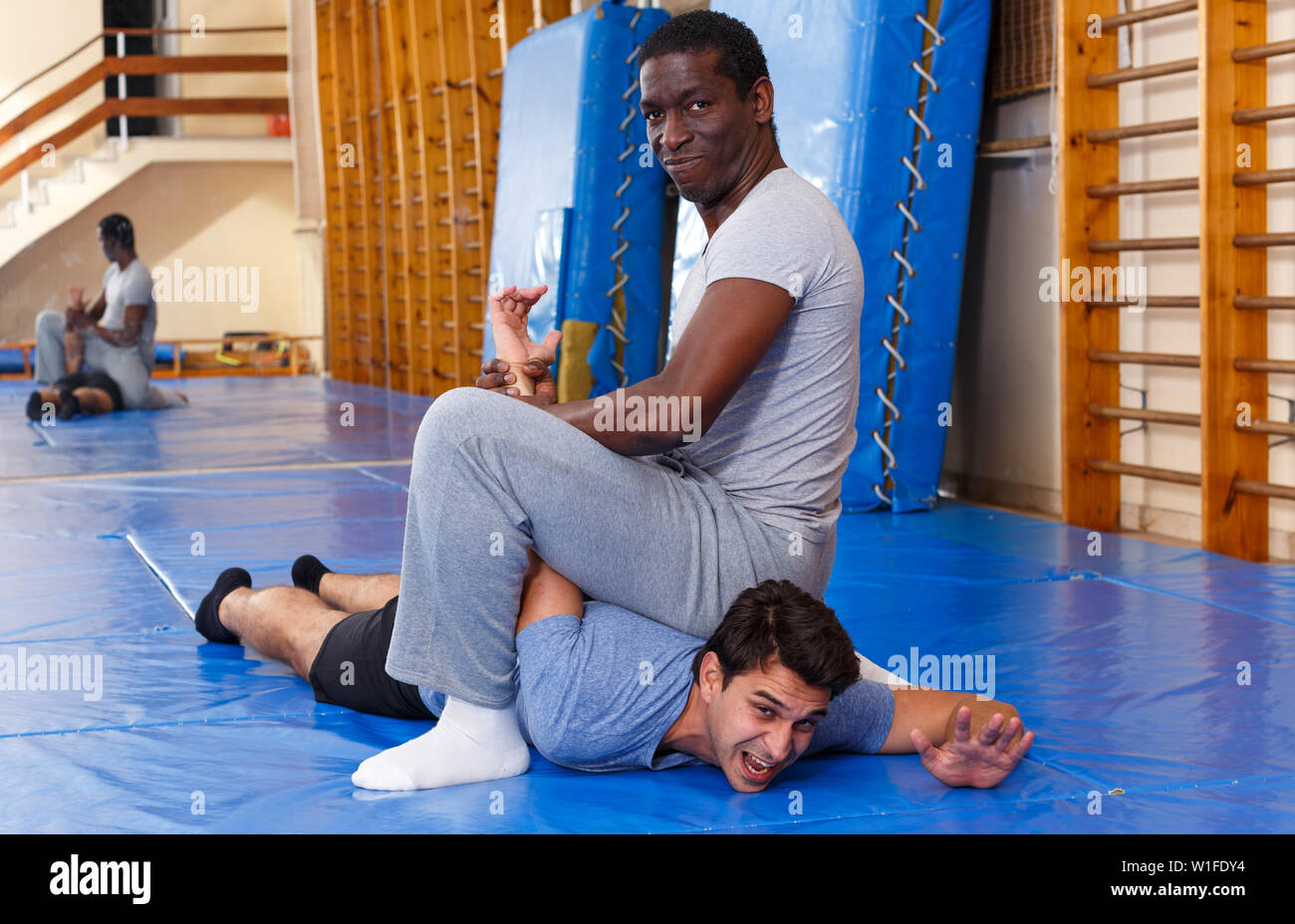 Men practicing effective techniques of self-defence during individual ...
