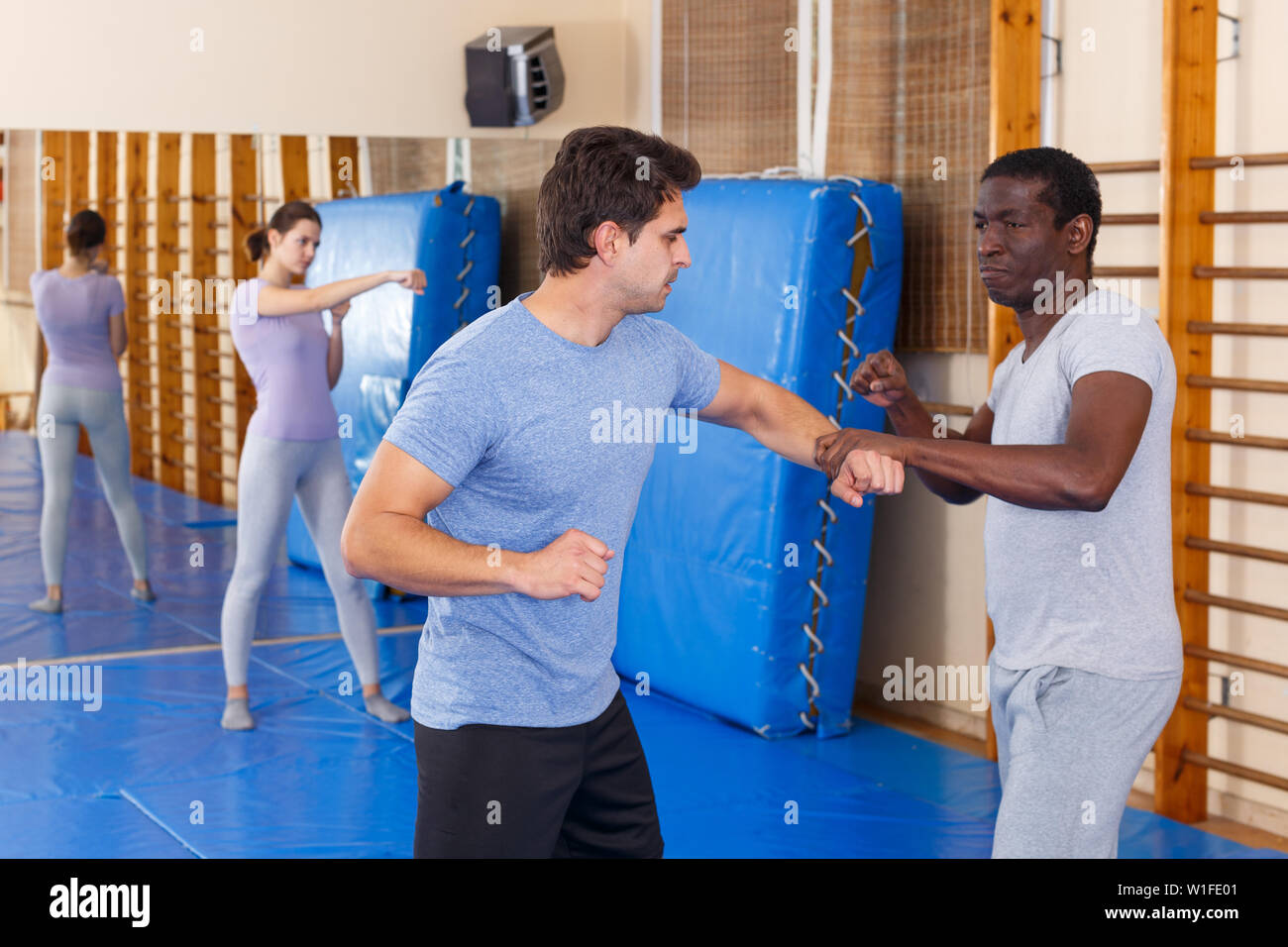 Men practicing effective techniques of self-defence during individual ...