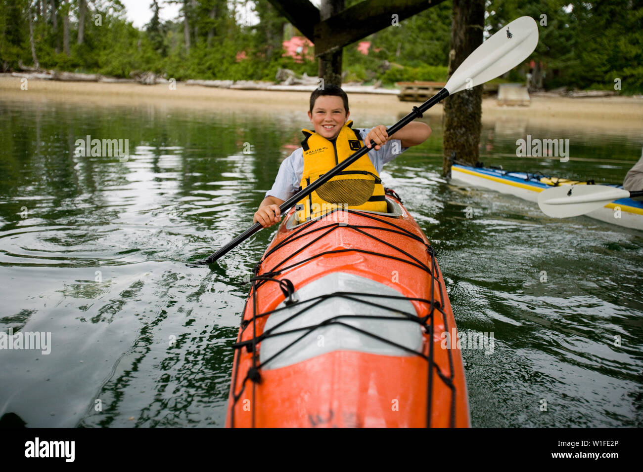 Portrait of a teenage girl paddling a kayak Stock Photo - Alamy