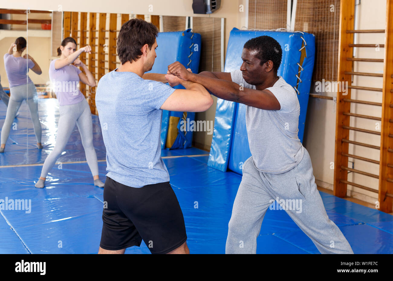Men practicing effective techniques of self-defence during individual ...