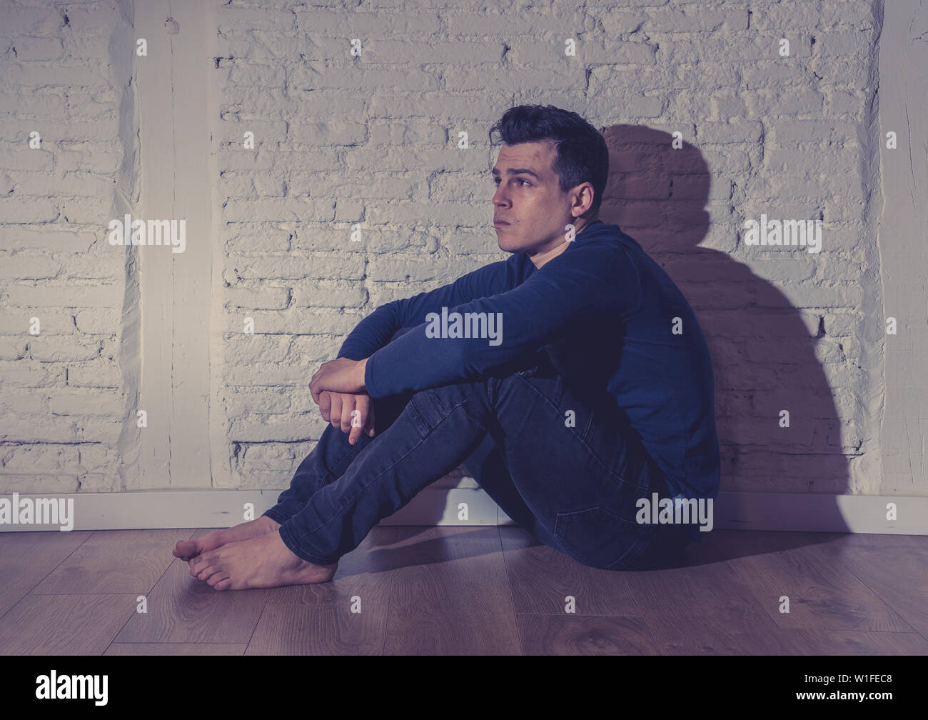 Portrait of sad depressed young man crying devastated feeling hurt ...