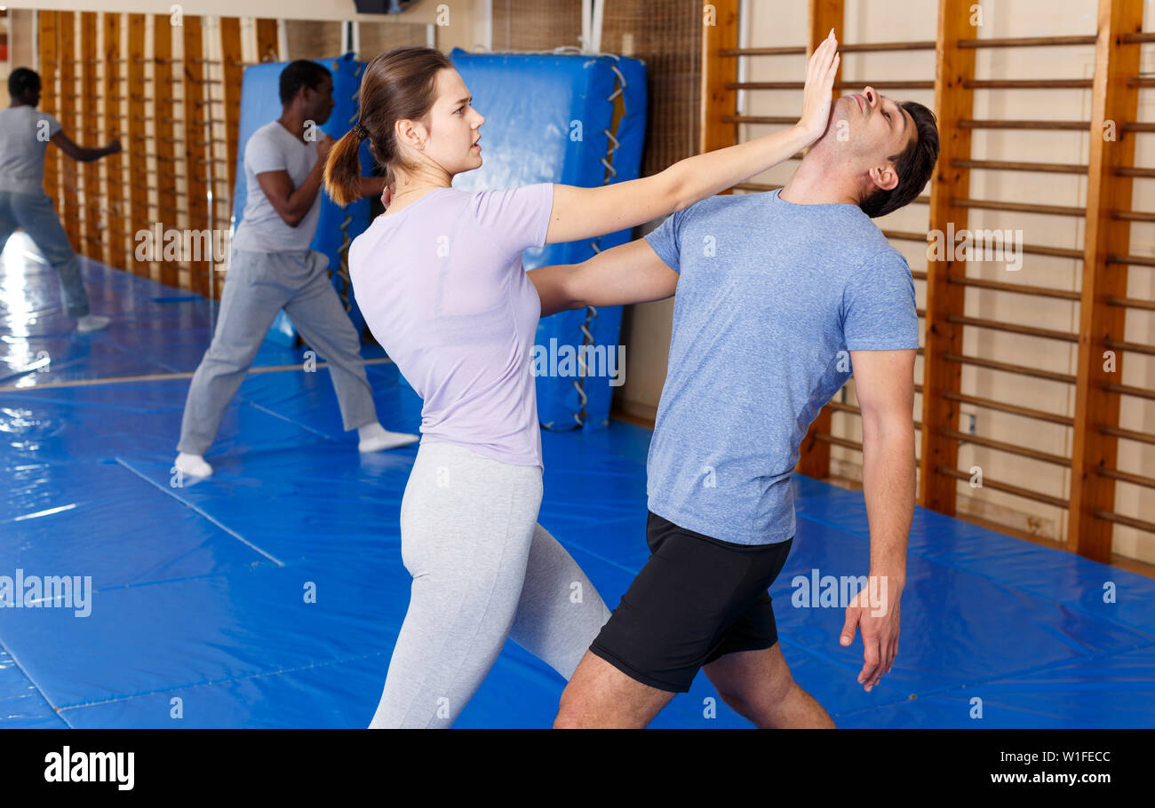Woman and man practicing self defense techniques in gym Stock Photo - Alamy