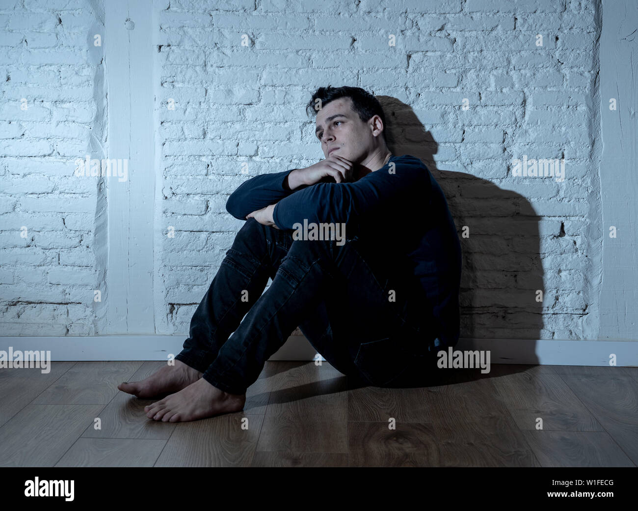 Portrait of sad depressed young man crying devastated feeling hurt ...