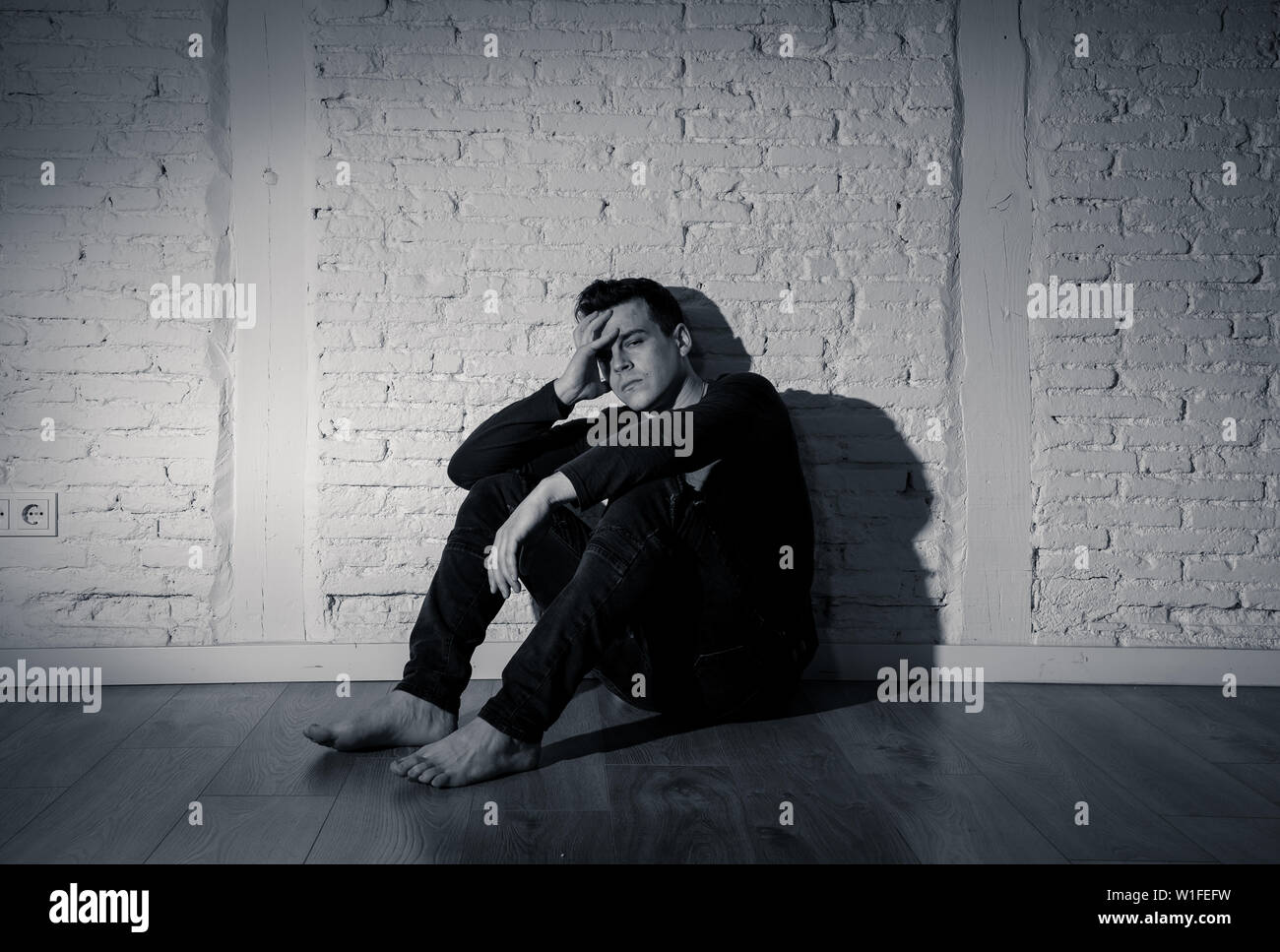 Portrait of sad depressed young man crying devastated feeling hurt ...