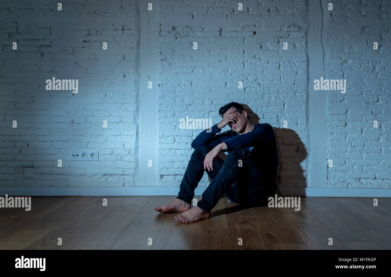 Portrait of sad depressed young man crying devastated feeling hurt ...