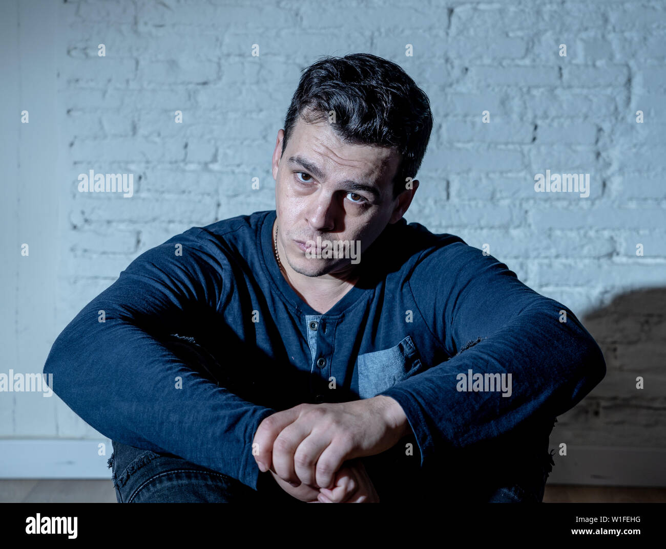 Portrait of sad depressed young man crying devastated feeling hurt ...