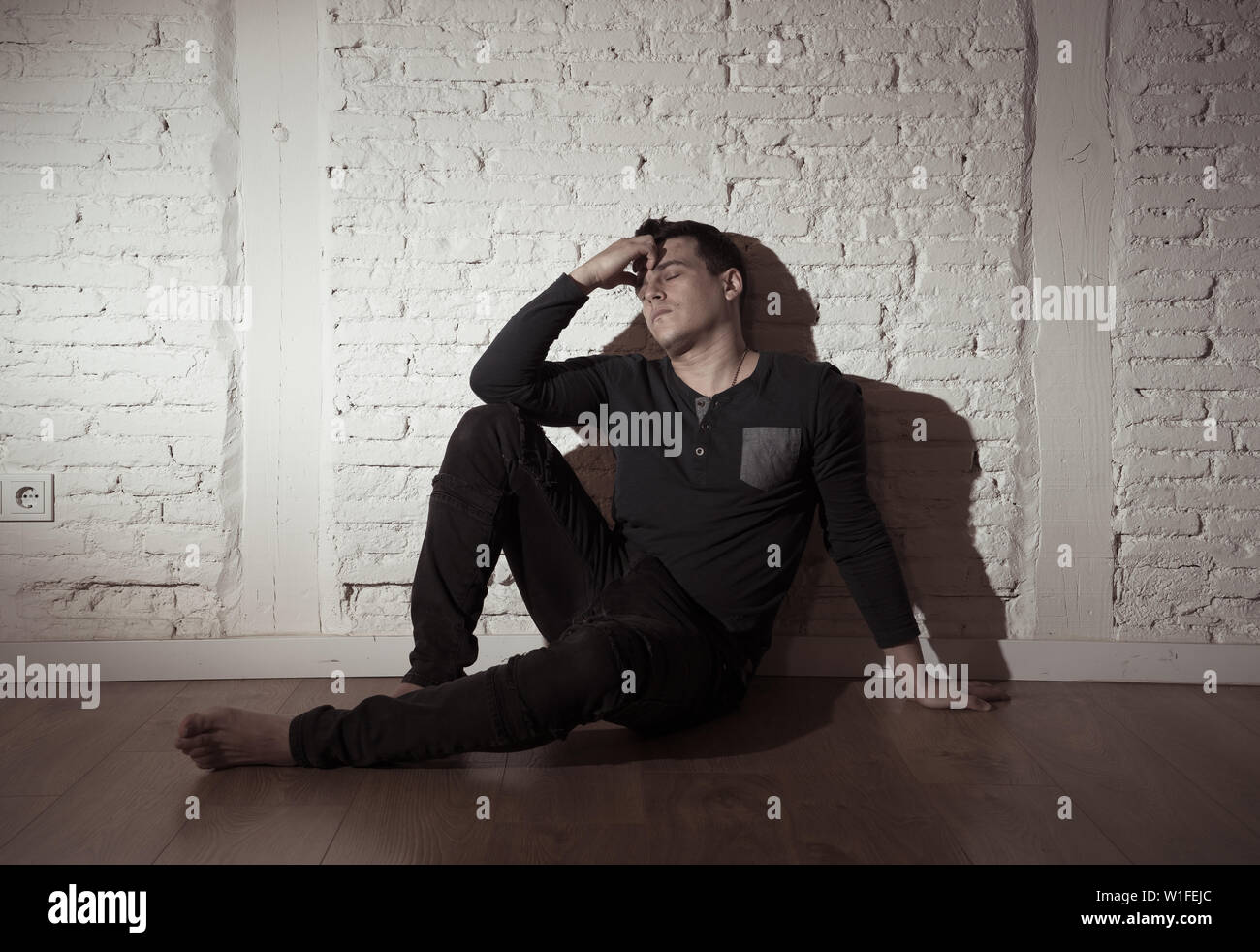 Portrait of sad depressed young man crying devastated feeling hurt ...