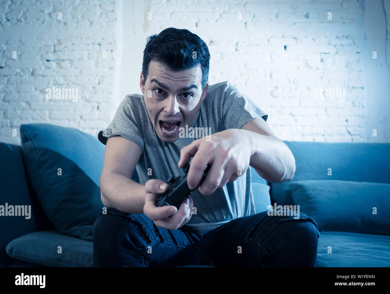 Portrait of young student man spending time playing video games using ...