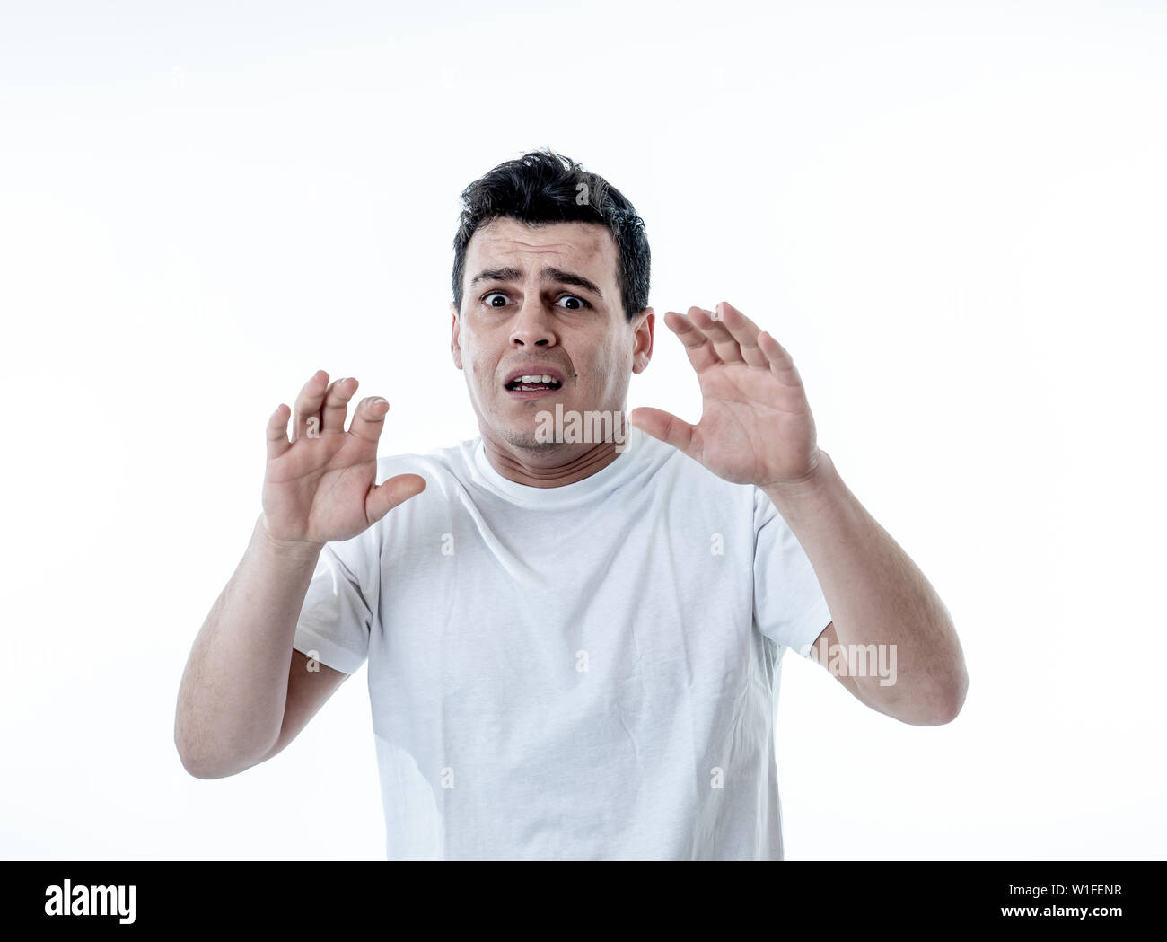 Portrait of young man in shock with a scared face expression making ...
