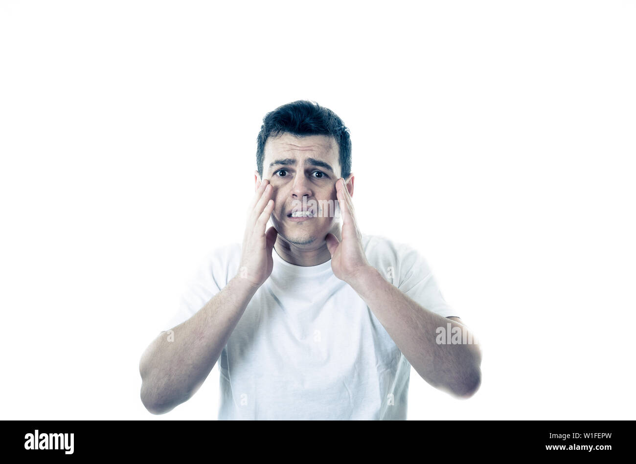 Portrait of young man in shock with a scared face expression making ...
