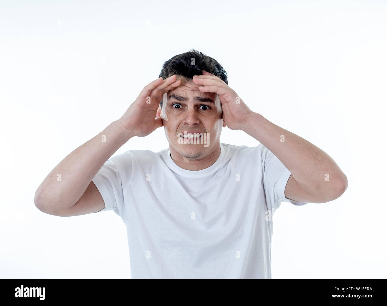 Portrait of young man in shock with a scared face expression making ...