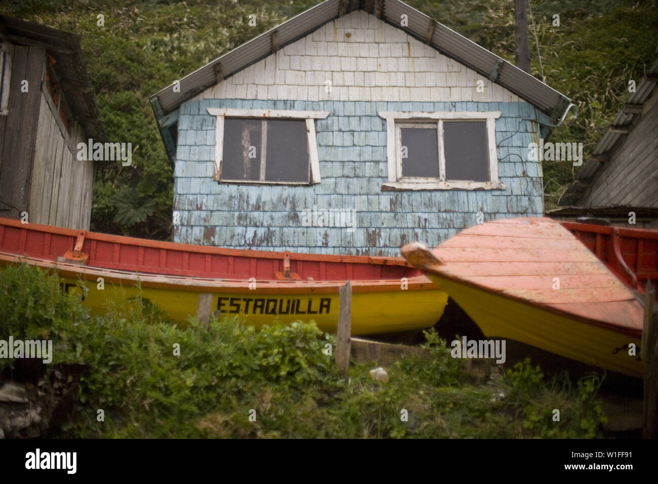 Old boats and a hut on a remote beach Stock Photo - Alamy