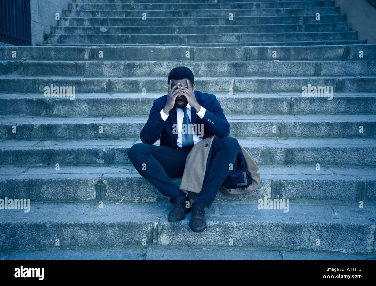 Young fired african american business man lost in depression crying ...