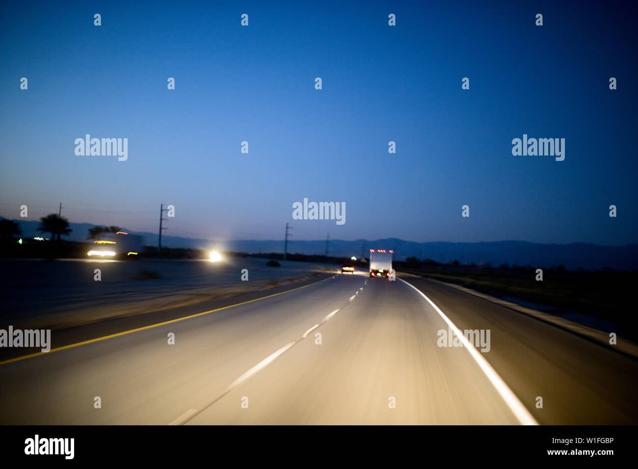 Traffic driving along a rural highway at night Stock Photo - Alamy