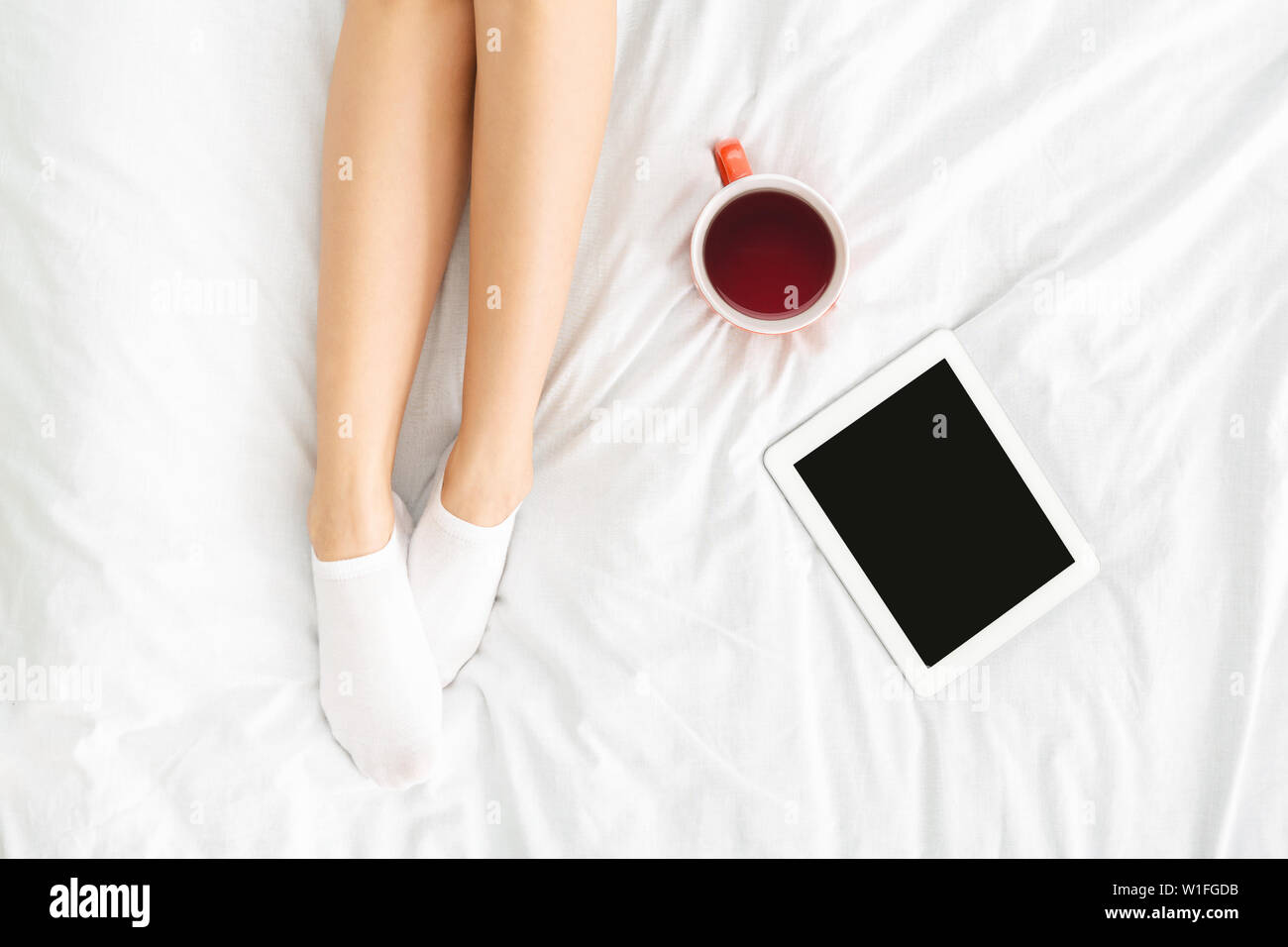 Legs cup of coffee bed relax hi-res stock photography and images - Alamy