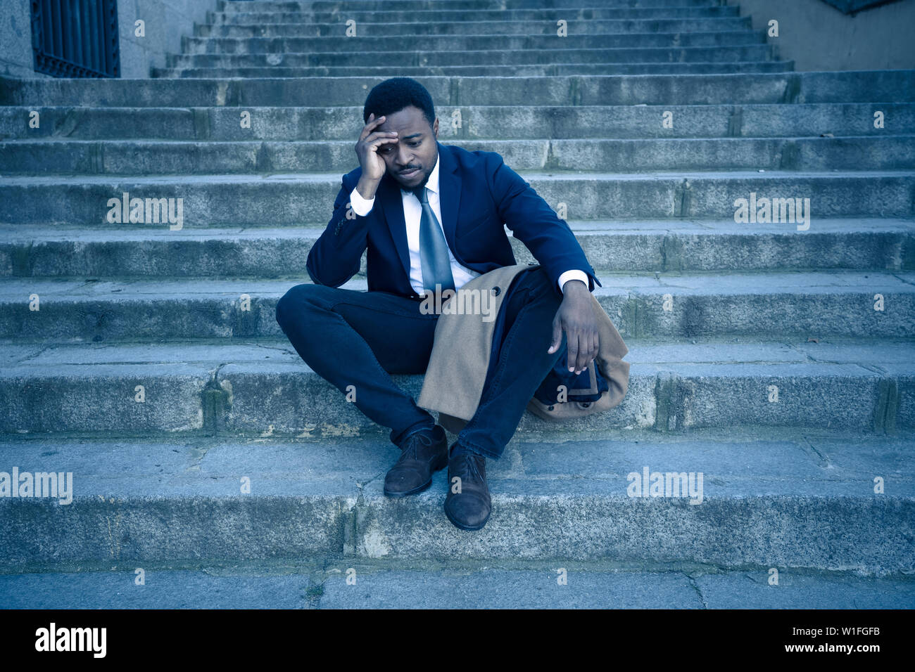 Young fired african american business man lost in depression crying ...