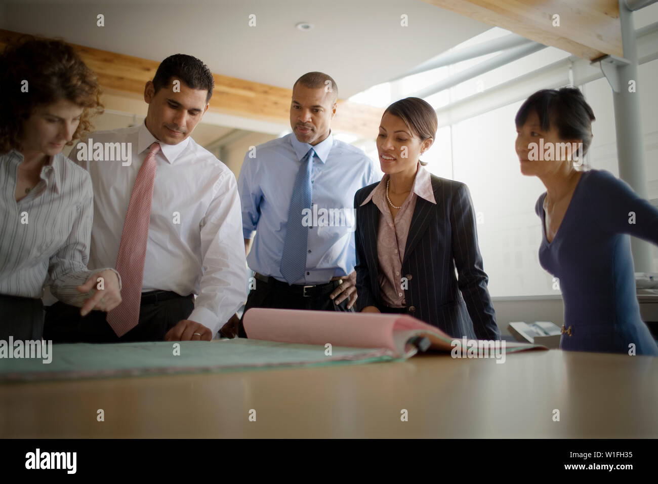 Business colleagues talking plans hi-res stock photography and images ...