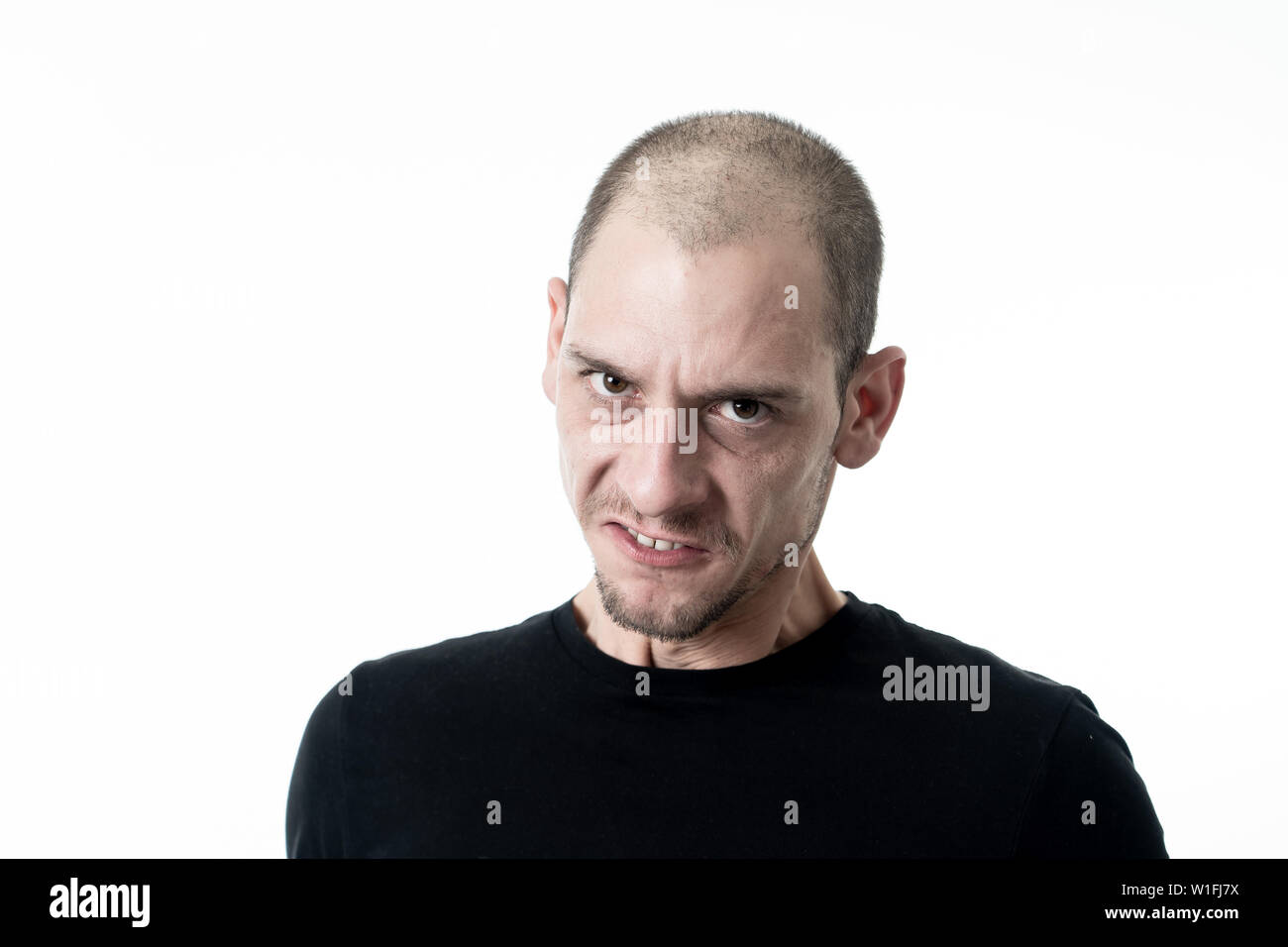 Portrait of angry and upset young man looking furious, aggressive and ...