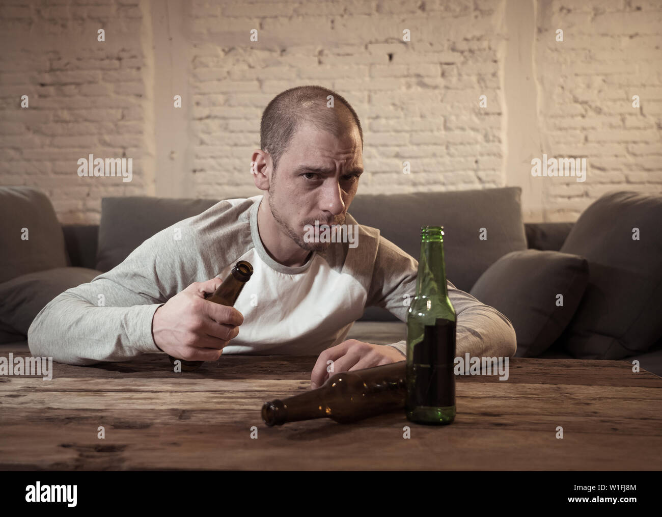 Young sad drunk men drinking beer and alcohol feeling wasted, lonely ...