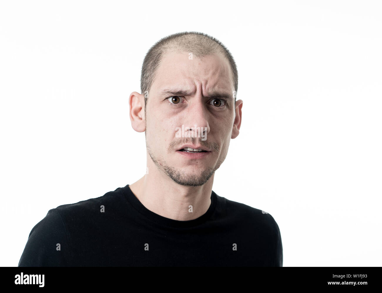 Portrait of angry and upset young man looking furious, aggressive and ...