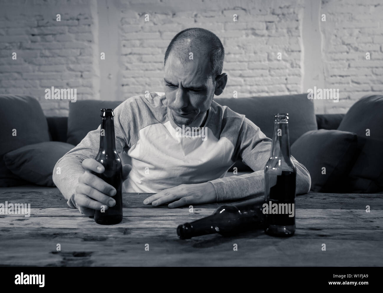 Young sad drunk men drinking beer and alcohol feeling wasted, lonely ...