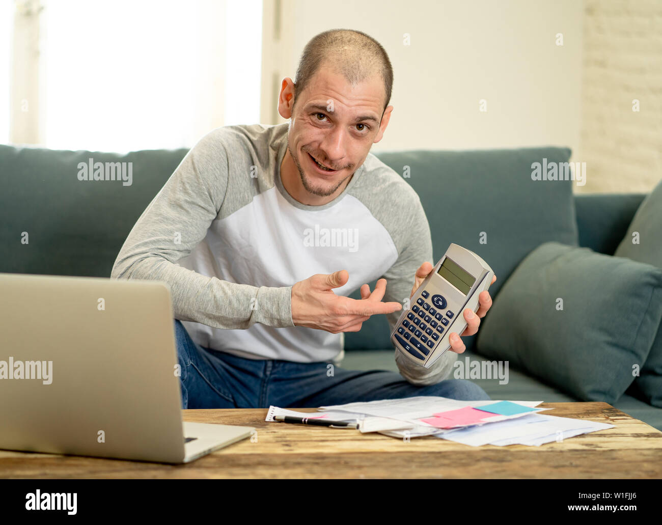 Young attractive caucasian creative self employed man accounting costs ...