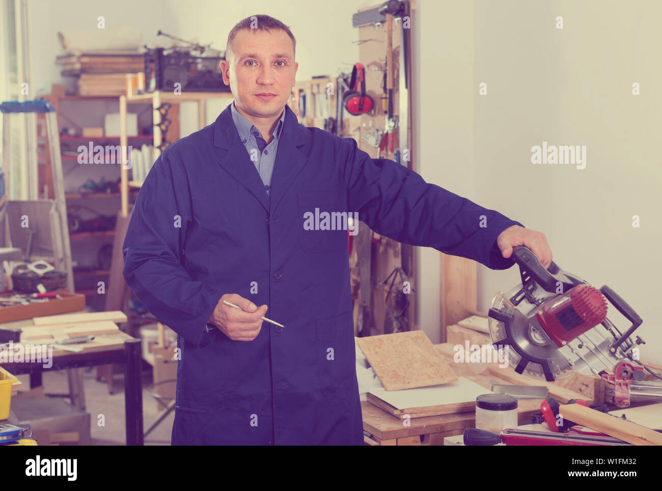 Portrait of smiling male handsome worker in uniform in workplace Stock ...