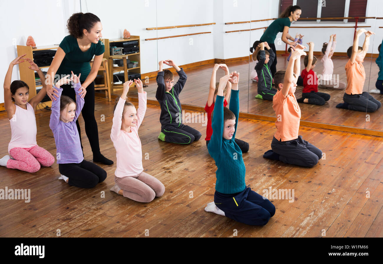 Little kids exercising with female teacher in dance class Stock Photo ...