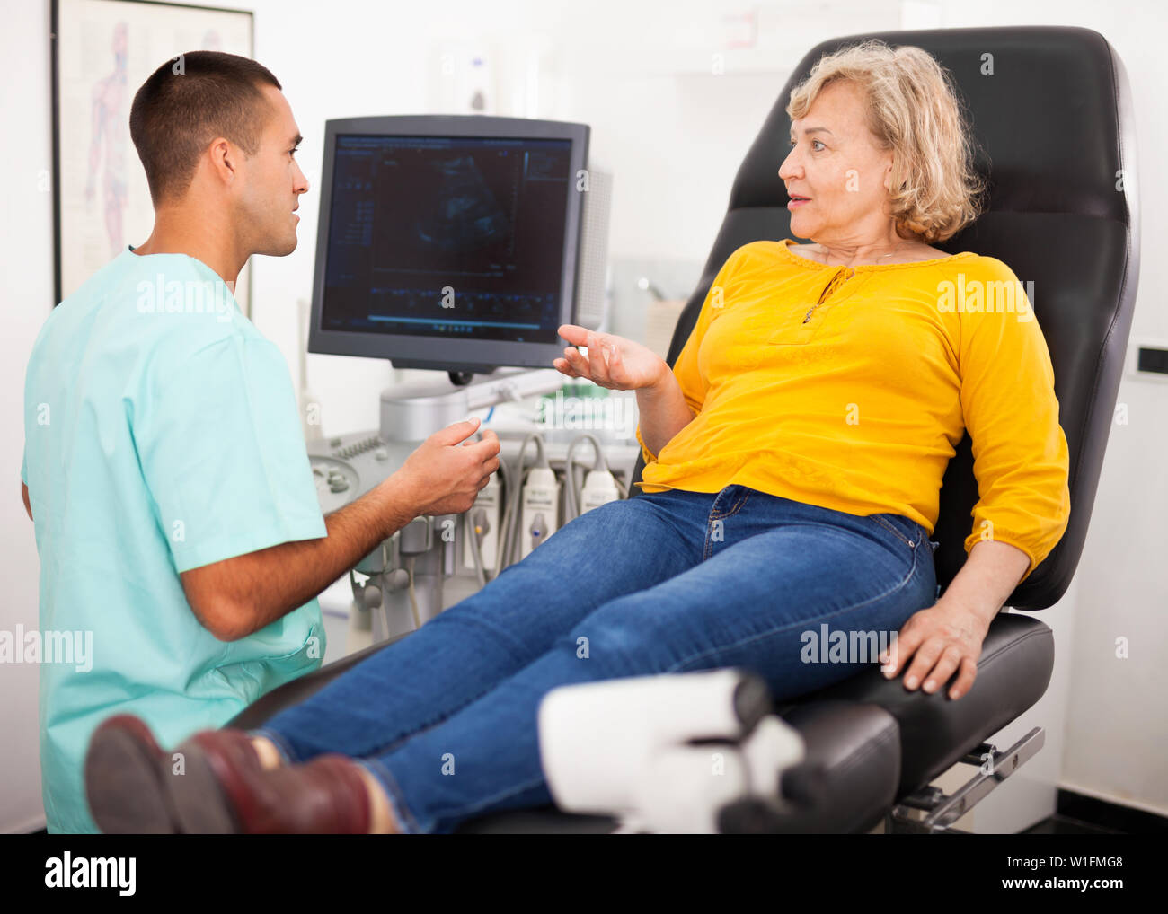 Skillful diligent efficient positive doctor consulting patient before ...