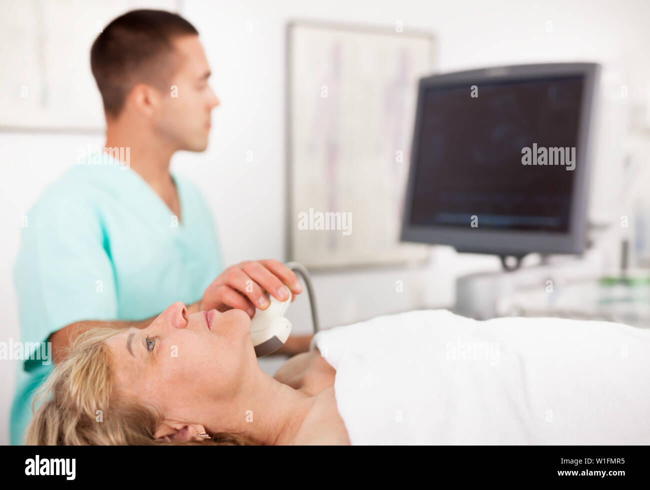 Female doctor using ultrasound probe hi-res stock photography and ...