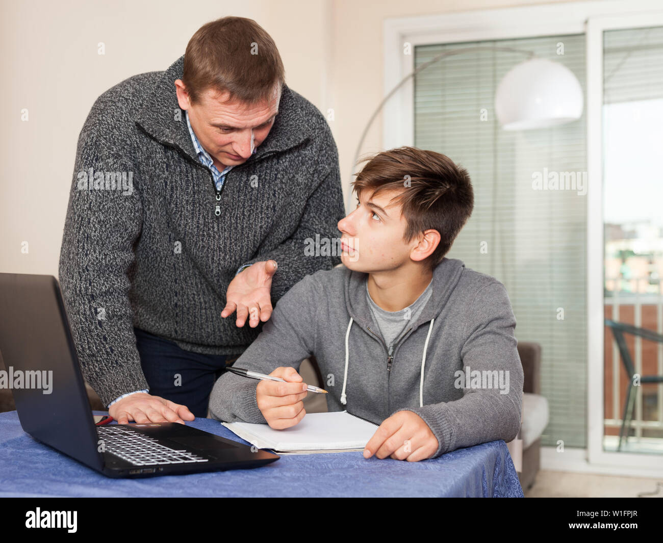Father scolds son for poor grades in school Stock Photo - Alamy