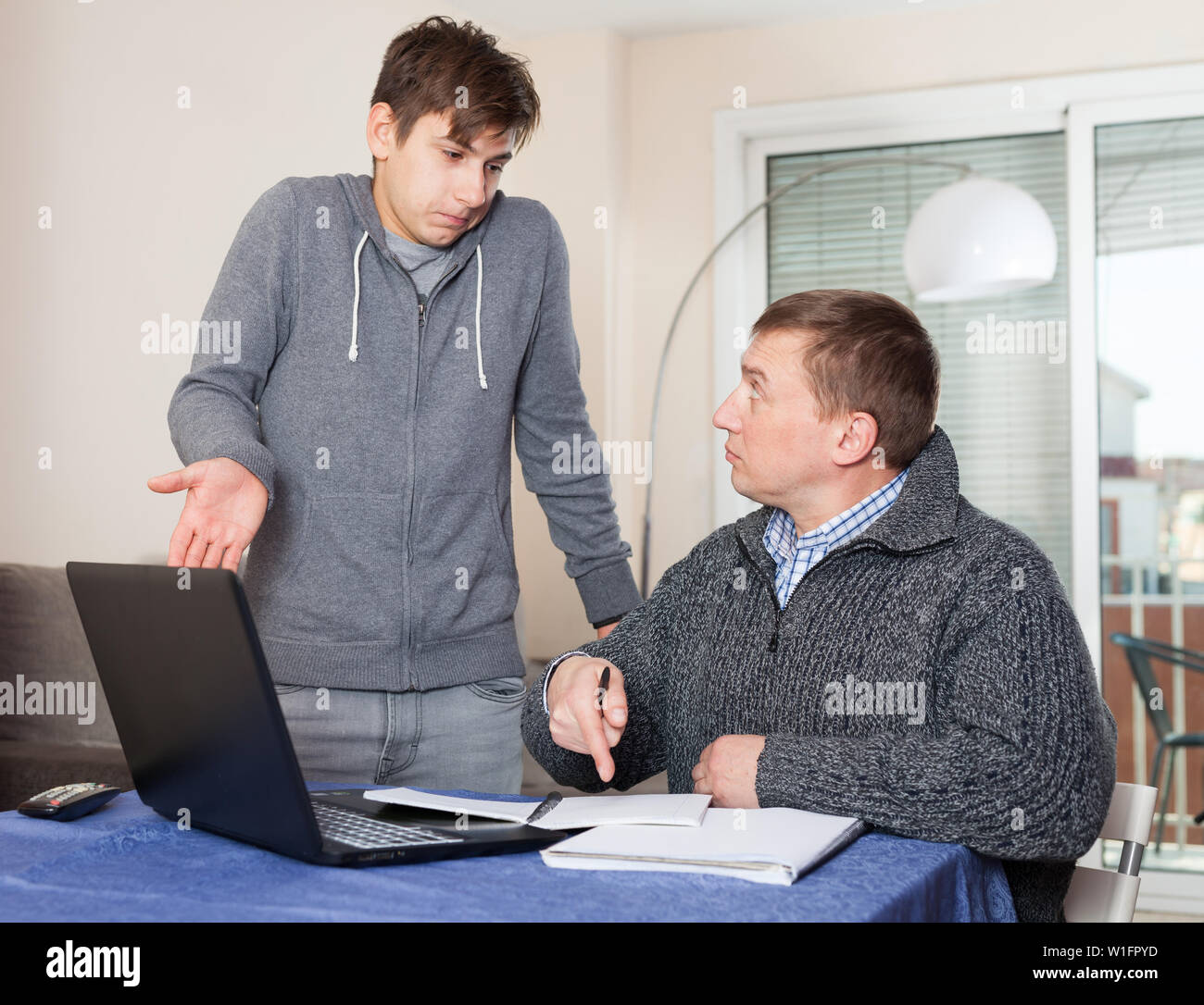 Father scolds son for poor grades in school Stock Photo - Alamy