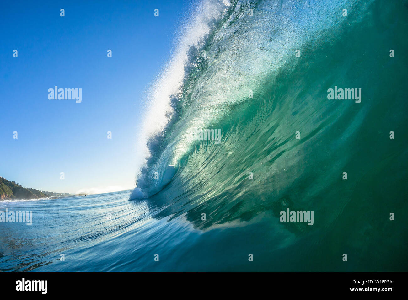 Ocean swimming closeup inside hollow crashing wave water towards camera ...