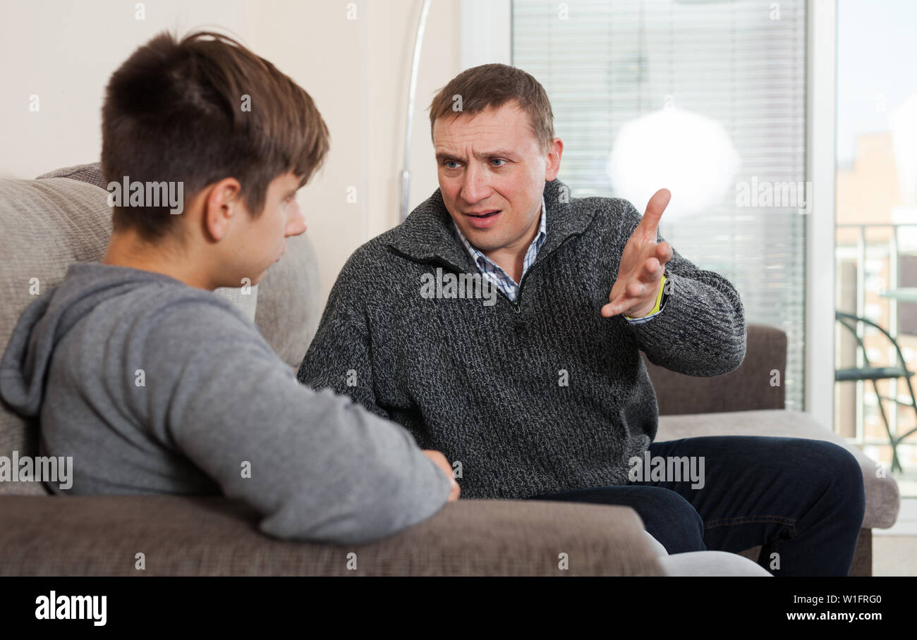 Angry father screaming at offender son Stock Photo - Alamy