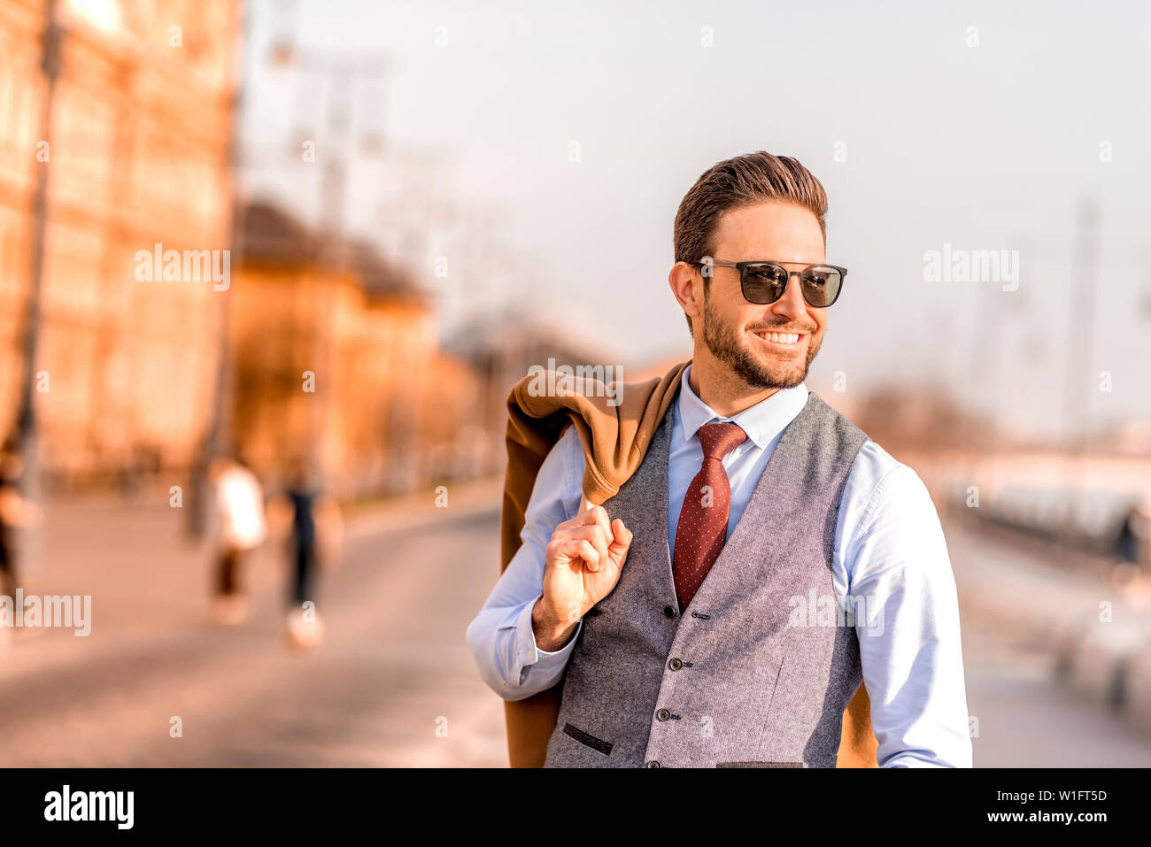 A handsome elegant man walking on the streets on a sunny day Stock ...