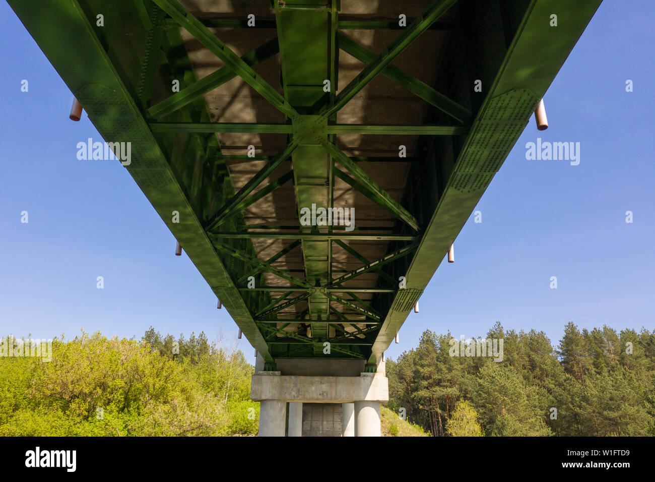 Drone view of bottom of the bridge with sun reflection from the water ...