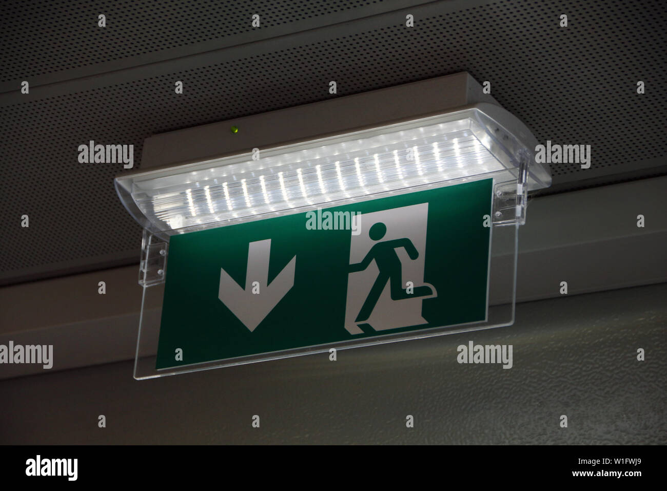 View of an emergency exit sign hanging on a ceiling Stock Photo - Alamy