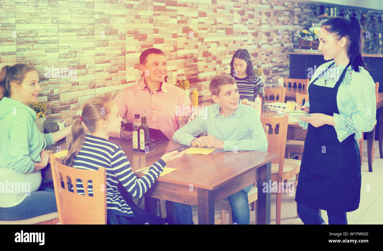 Adult waitress taking order from guests and writing into note Stock ...