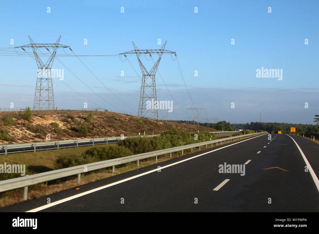 Close view of big electricity towers next to road Stock Photo - Alamy