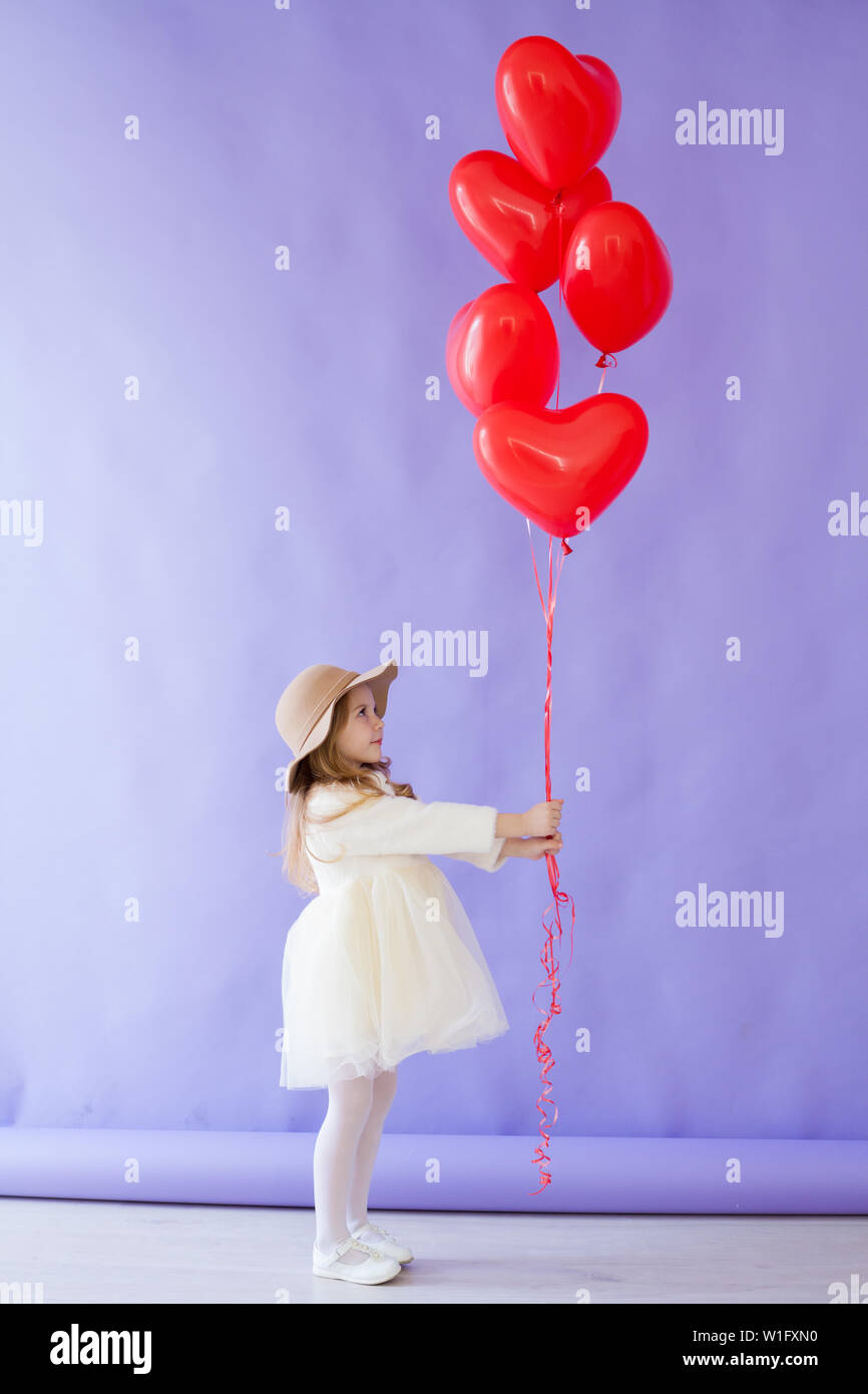 beautiful girl sits with red heart balloons Stock Photo - Alamy