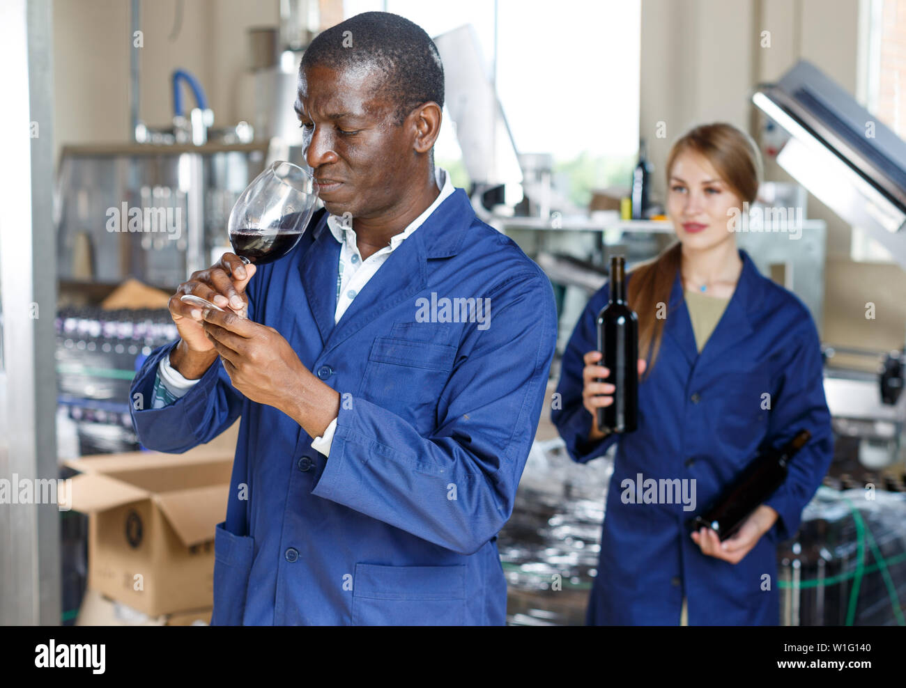 Confident male worker of winery testing new wine in glass Stock Photo ...