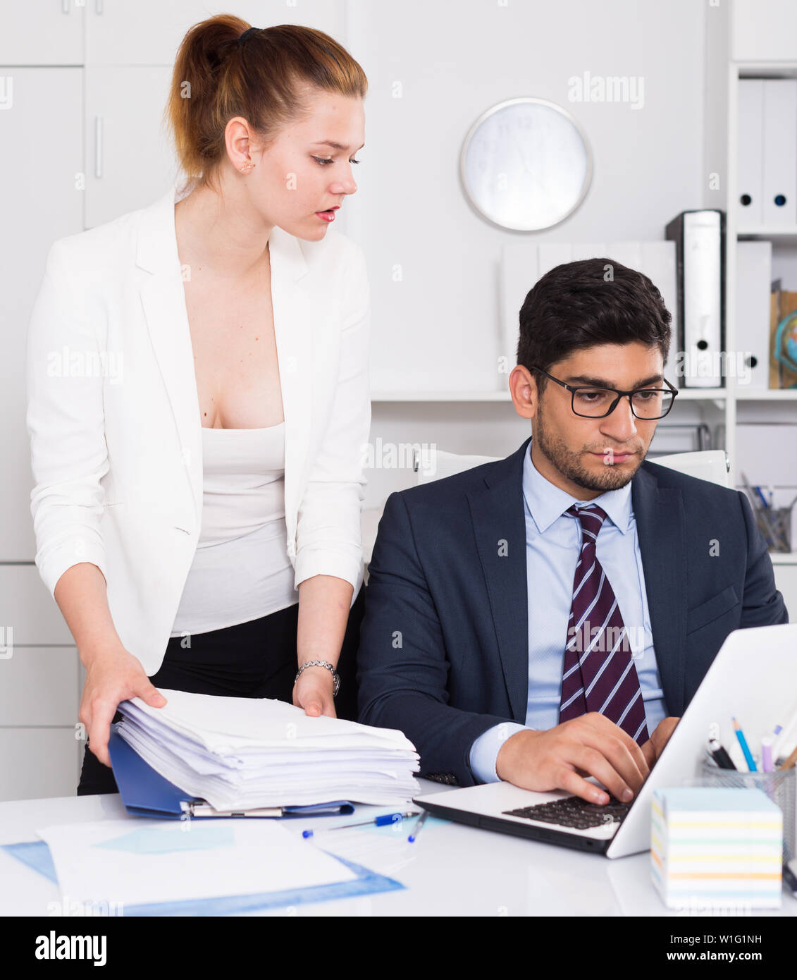 Office worker shocked by huge stack of papers brought by his boss Stock ...