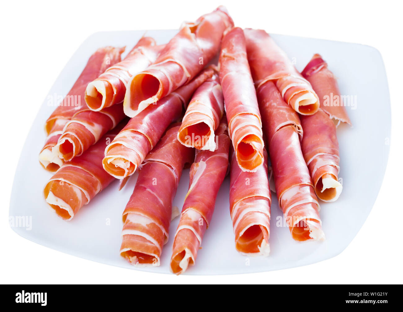 Traditional Spanish meal - rolls of iberian jamon served at plate ...