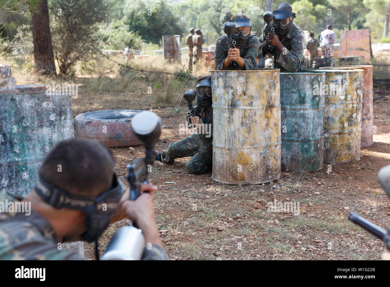 Teams facing on battlefield in outdoor paintball arena Stock Photo - Alamy