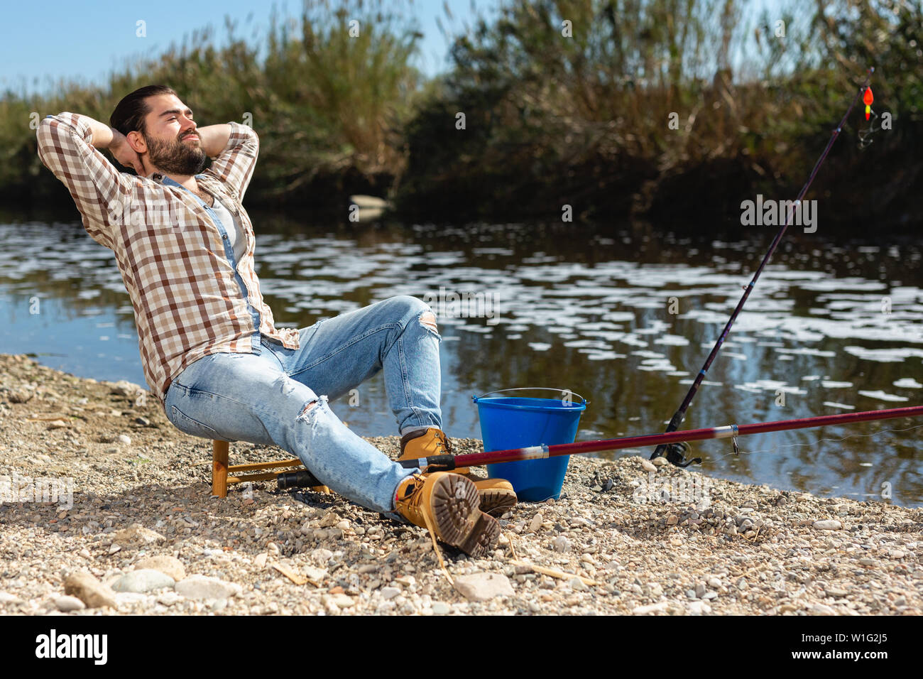 Man Sitting On Bucket Fishing High Resolution Stock Photography and ...